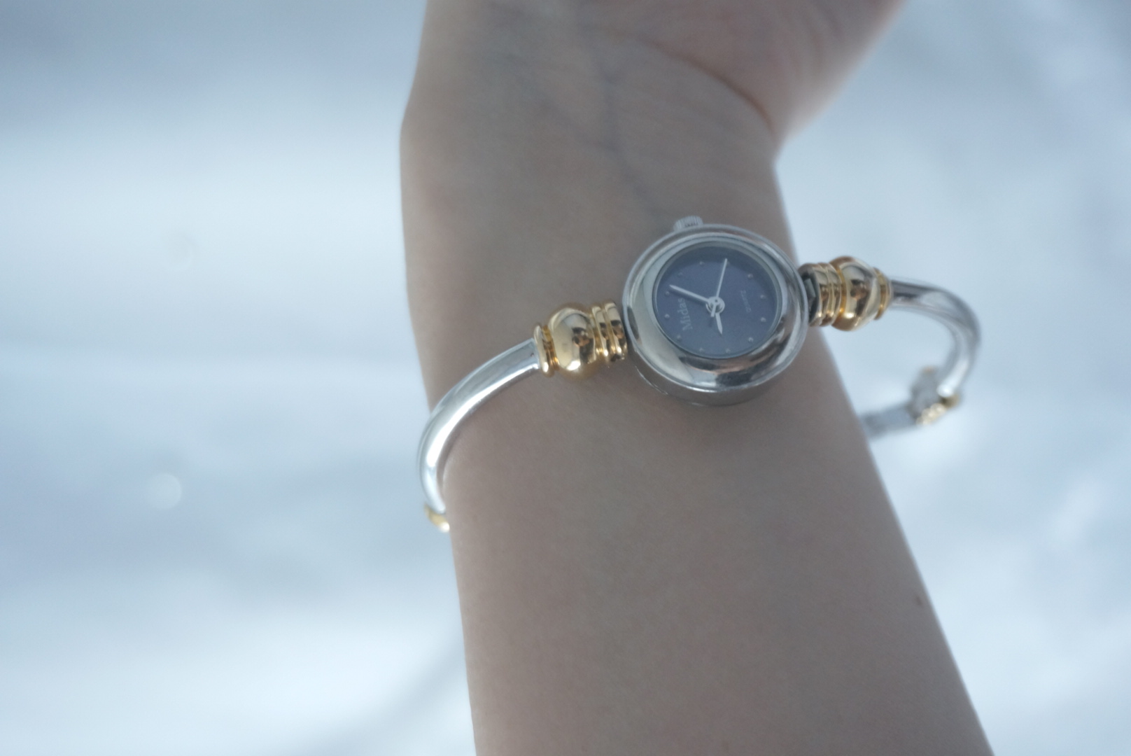 metallic circular watch